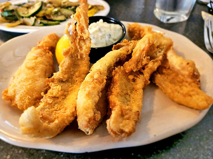 Golden-fried lake perch that crunches like autumn leaves, served with a side of tartar sauce that complements rather than overwhelms.