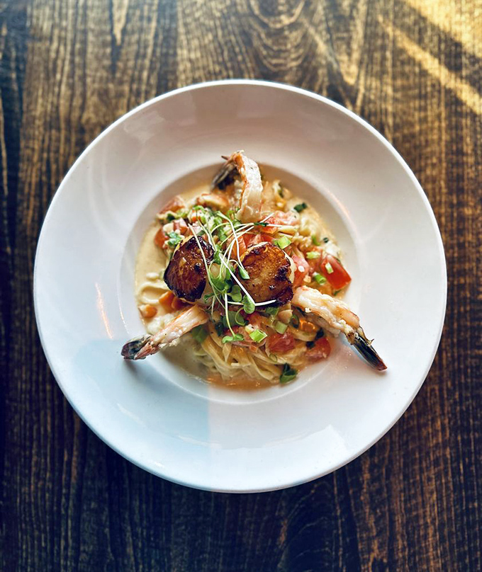 A seafood pasta that whispers "I learned this in Italy" but shouts "I perfected it in California!" &ndash; where shrimp and scallops become the stars of their own delicious show.