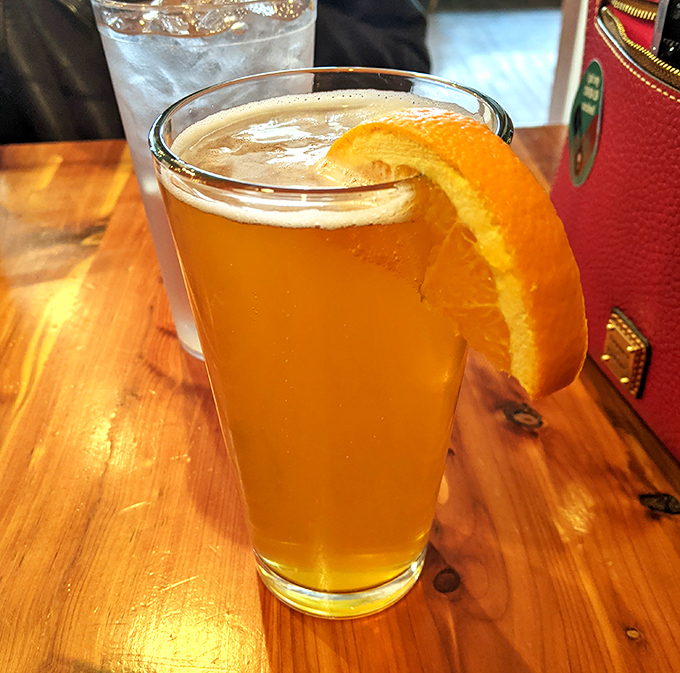 A craft beer with an orange slice&mdash;because sometimes your palate needs a bright, citrusy intermission between acts of smoky intensity.