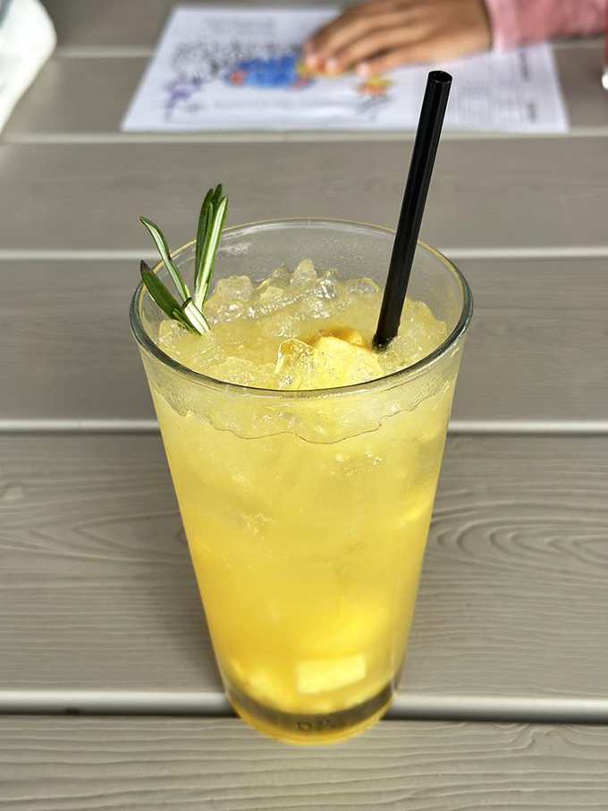 A sunshine-colored spritz garnished with rosemary&mdash;like summer decided to dress up fancy but keep things refreshingly casual.