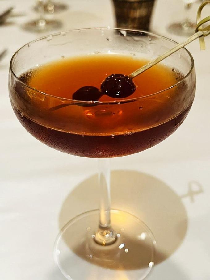 This Manhattan isn't just a cocktail, it's a liquid amber sunset in a glass, complete with those perfect brandied cherries.
