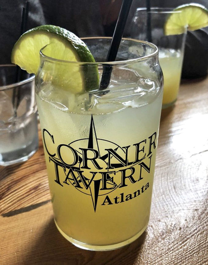 A proper margarita in a branded glass – sunshine in liquid form. The lime perched on the rim isn't just garnish, it's an invitation.