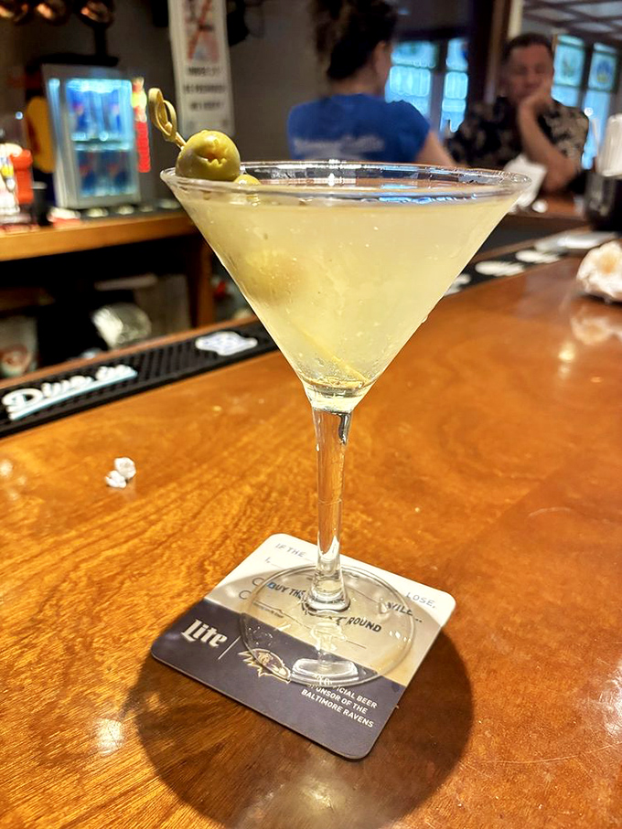 A martini so clear it could pass a transparency test, garnished with an olive standing guard. James Bond would approve of this shaken masterpiece.