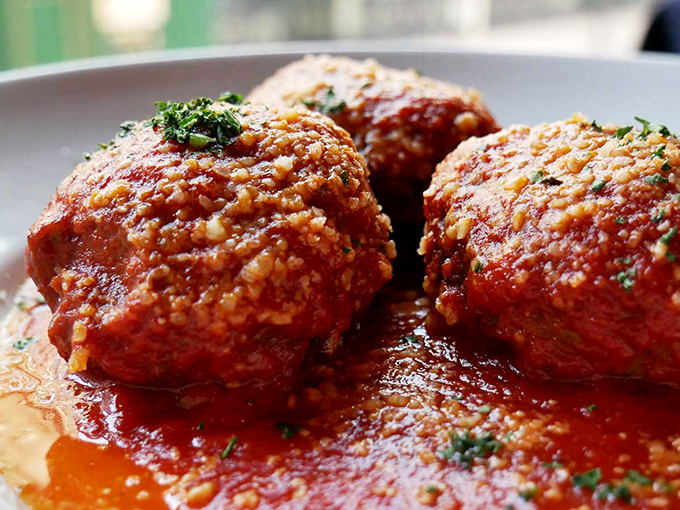 These aren't your grandmother's meatballs (unless your grandmother was a culinary genius). Massive, tender, and swimming in sauce that demands to be savored.