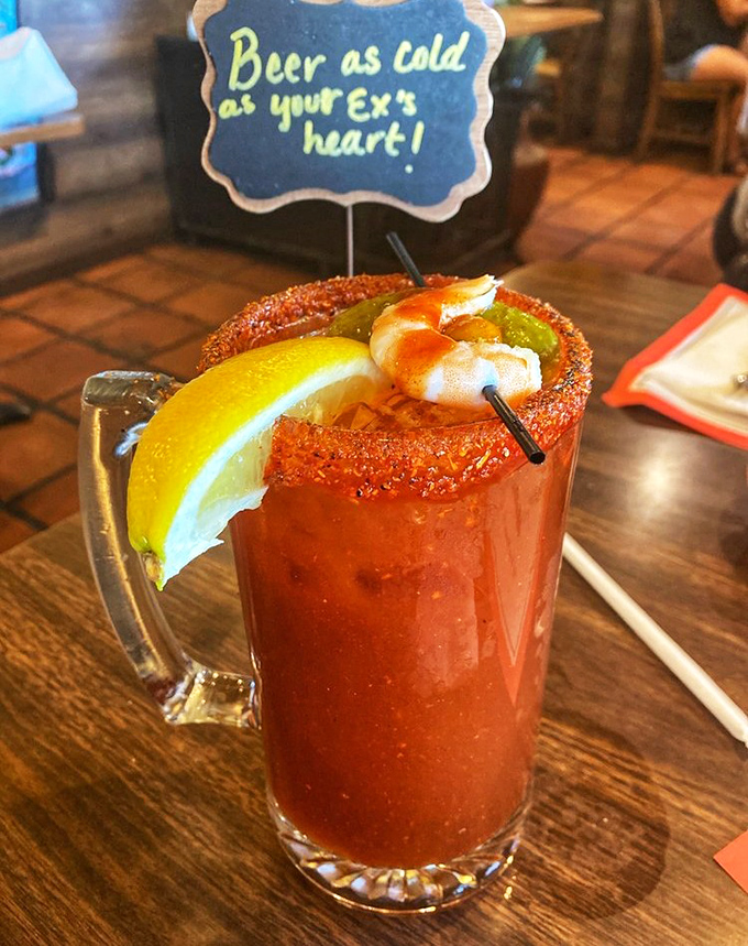 "Beer as cold as your ex's heart" promises the sign, but this Michelada delivers warmth with its spicy rim and tangy tomato base.