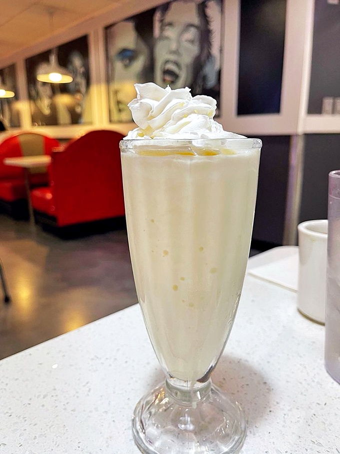 This isn't just a milkshake; it's a dessert with a drinking problem. That whipped cream mountain deserves its own zip code.