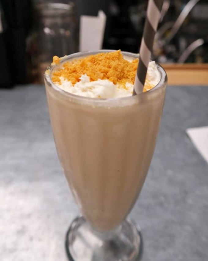 Dessert or work of art? This creamy milkshake topped with crumbled treats proves that sometimes the best automotive fluids are sweet, cold, and come with a straw.