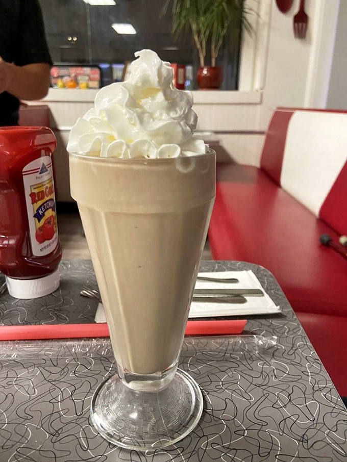 This isn't just a milkshake &ndash; it's a tower of creamy nostalgia topped with a cloud of whipped cream that demands both a spoon and straw.