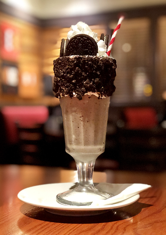 This isn't just a milkshake; it's a structural engineering marvel topped with cookies, whipped cream, and zero nutritional guilt.