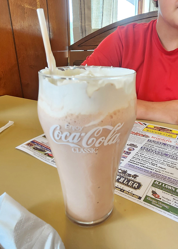 The milkshake arrives in its natural habitat &ndash; a classic Coca-Cola glass, thick enough to make your straw stand at attention.