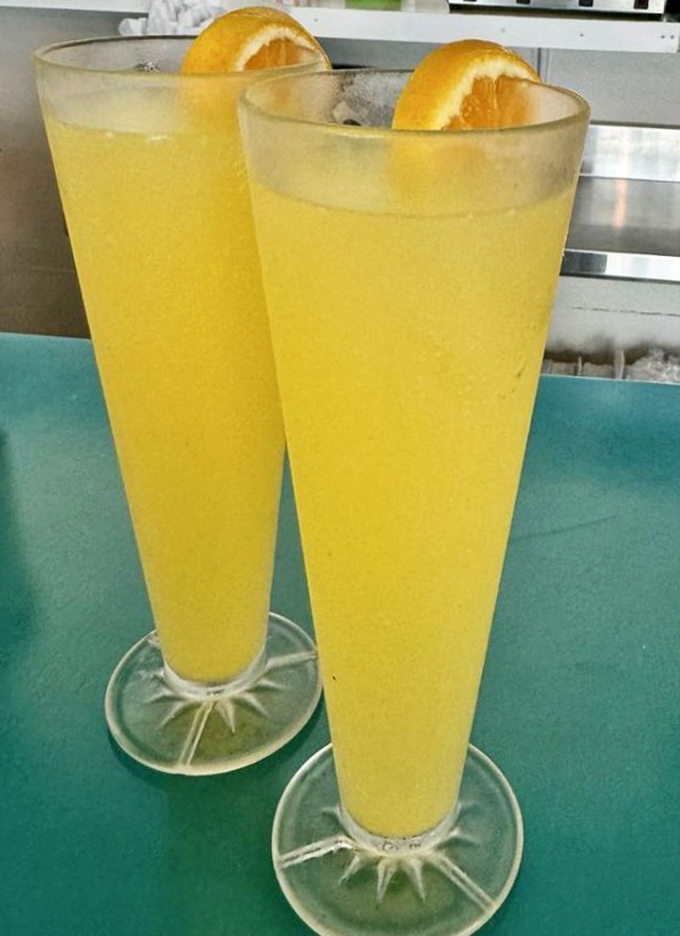Nothing says "I'm officially on vacation" quite like these sunrise-colored mimosas, tall enough to make your Monday morning meeting seem very, very far away.