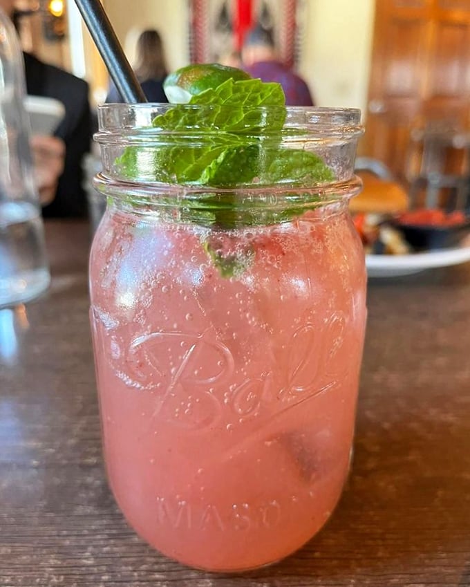 This isn't just a pink drink; it's summer in a Mason jar with mint leaves standing guard over your moment of refreshment.