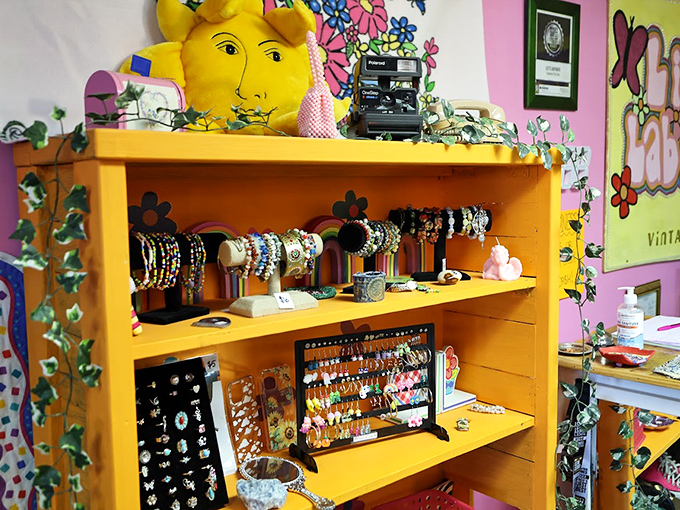 Jewelry heaven on a sunshine-yellow bookcase. That Polaroid camera isn't just decoration&mdash;it's waiting to capture your "found treasure" moment.
