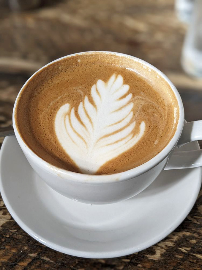 Latte art so pretty you almost don't want to drink it. Almost. That leaf design is practically begging for its Instagram moment.