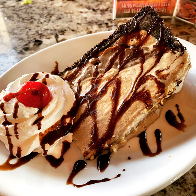 This isn't just dessert, it's therapy—layers of chocolate and cream creating the kind of mud pie that makes grown adults reluctant to share.