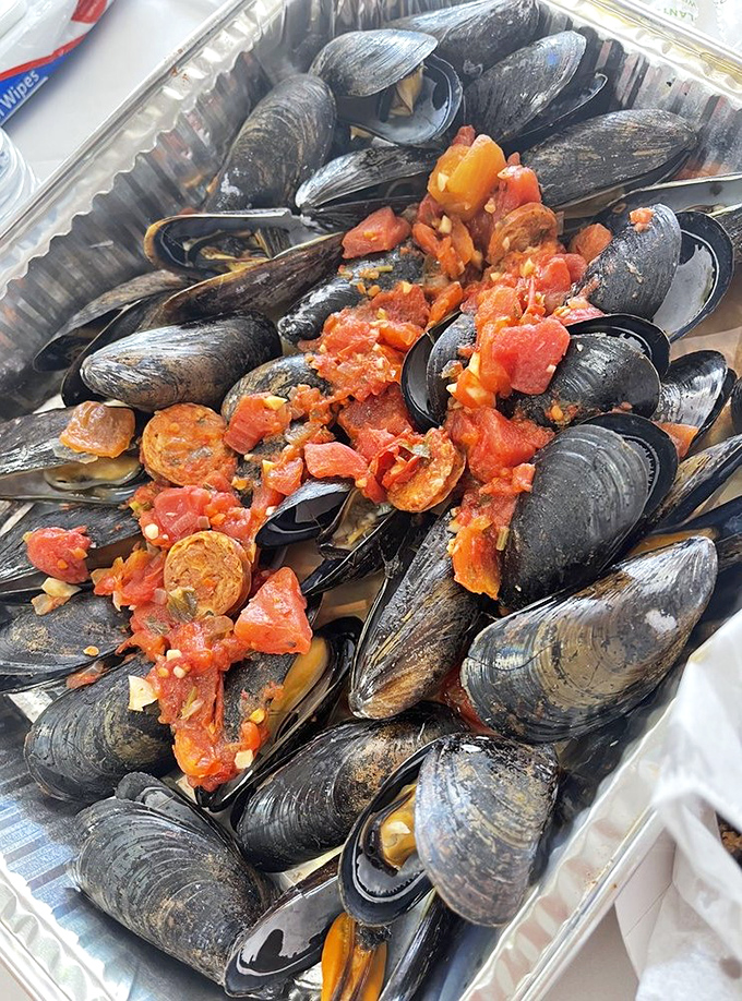 These mussels aren't just seafood; they're little black cauldrons of tomato-infused ocean magic. Bread for dipping is mandatory.