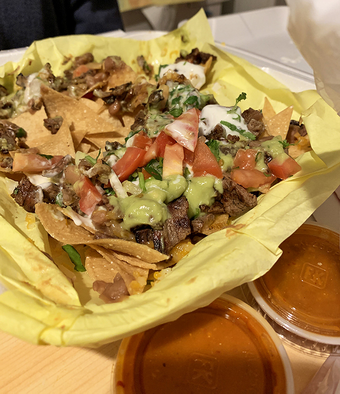 Loaded nachos that could feed a small army or one very determined food enthusiast with excellent priorities.