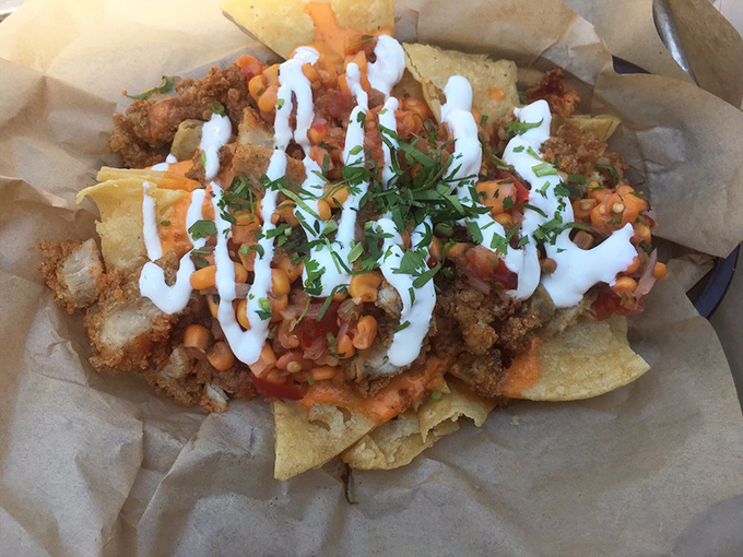 Nachos reimagined with fried chicken &ndash; because sometimes traditional boundaries need breaking. A symphony of textures and flavors that defies categorization.