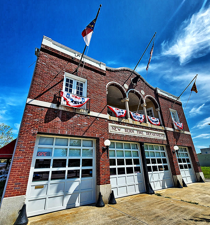 New Bern's historic Fire Department building proudly displays its heritage. Where firefighting history meets small-town pride, complete with patriotic bunting that would make Uncle Sam weep with joy.
