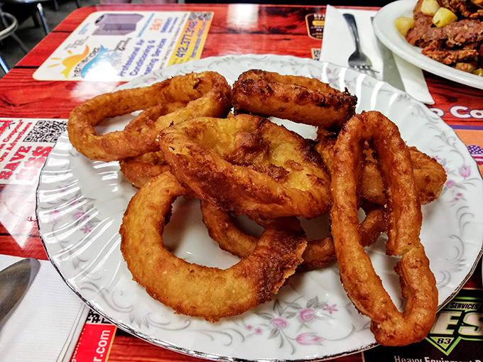 Onion rings with the structural integrity of architecture and the golden hue that signals deep-fried perfection. Diet food? Absolutely not. Worth it? Every crispy bite.