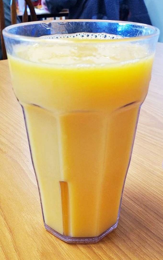 Orange juice so vibrant it's like California sunshine in a glass, making your morning vitamin C requirement actually enjoyable.