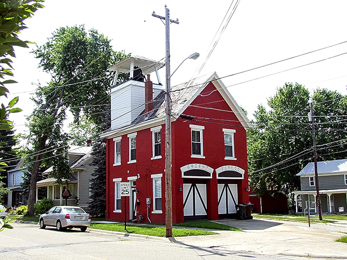 The Orient Firehouse stands as a crimson reminder of simpler times, when emergency calls came from actual bells, not smartphone alerts.