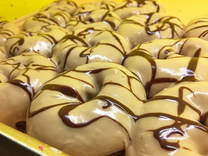 Maple-glazed donuts with a drizzle of chocolate creating a hypnotic pattern that whispers, "Diet? What diet? We need to talk."