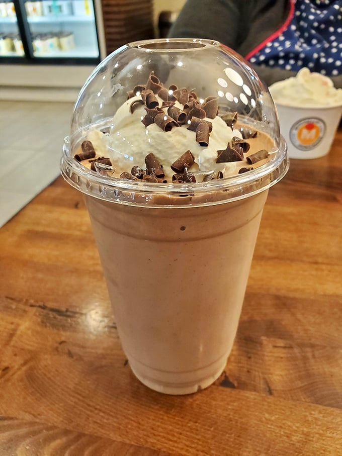 This isn't just a milkshake—it's a drinkable dessert masterpiece topped with chocolate shavings that would make Elvis weep with joy.