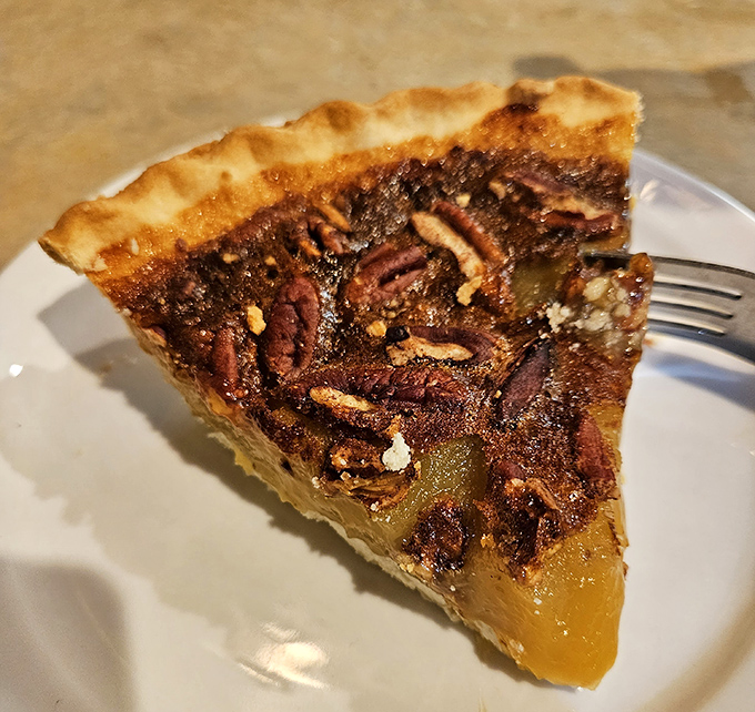 Pecan pie so rich it should come with its own tax bracket—a perfect balance of gooey filling and crunchy nuts.