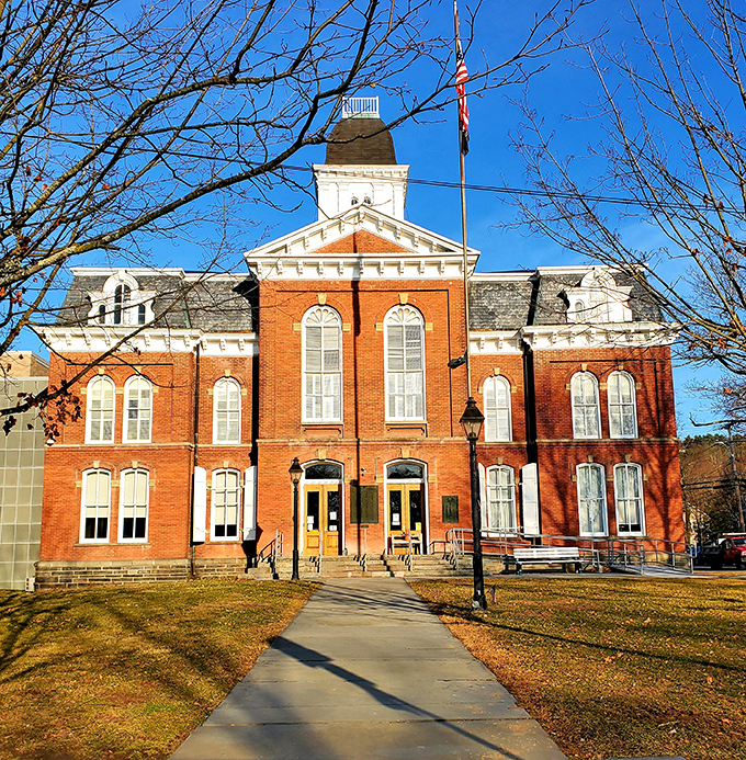 The Pike County Courthouse basks in golden hour light, its brick fa&ccedil;ade and white trim a testament to civic architecture that actually makes you feel patriotic.