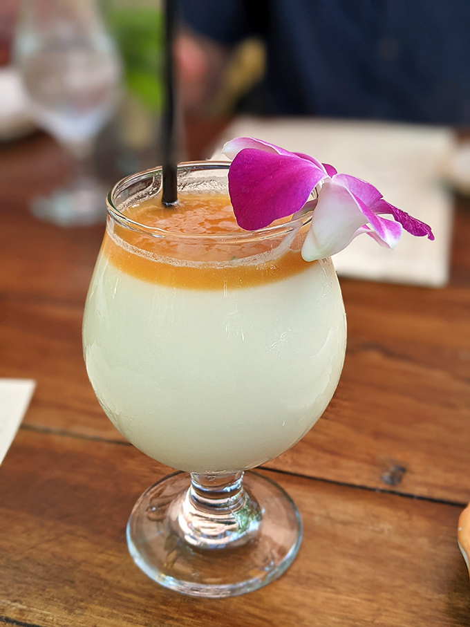 Not your college spring break pi&ntilde;a colada. This tropical cloud topped with an orchid is what happens when bartenders actually respect their ingredients.