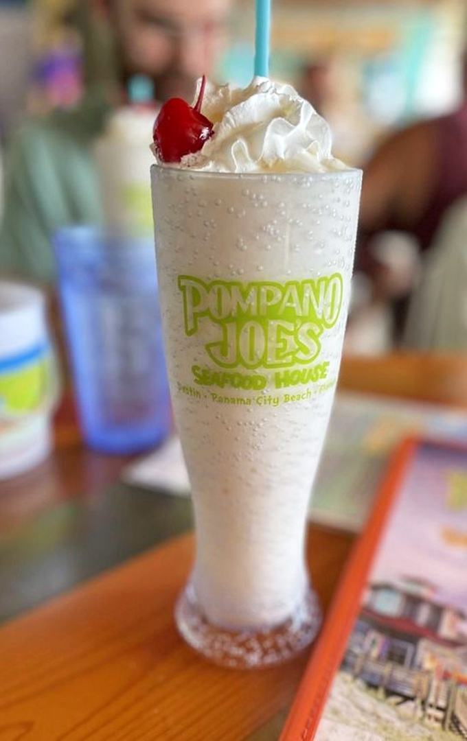 A pi&ntilde;a colada tall enough to hide behind during awkward conversations, topped with whipped cream and a cherry that says "vacation starts now."