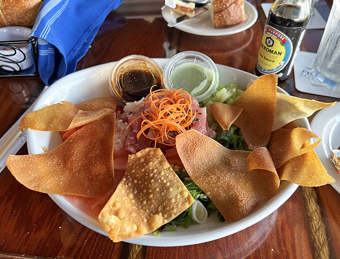 This poke bowl isn't just lunch – it's edible art, where crispy wonton chips stand guard around jewel-toned fish and vibrant vegetables.