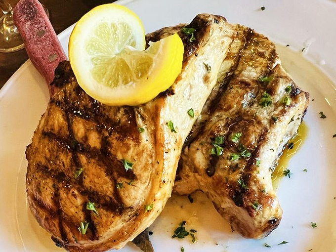 Grilled pork chops with a perfect char mark pattern that would make a geometry teacher proud. The lemon wedge isn't just garnish&mdash;it's essential flavor architecture.