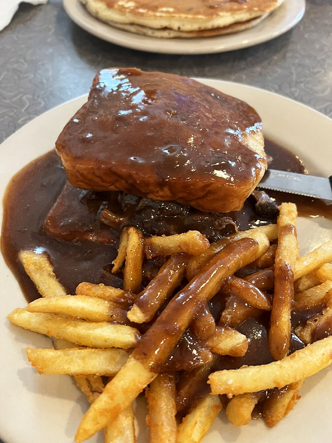 Pot roast so tender it practically falls apart at first glance, accompanied by vegetables that know their supporting role.