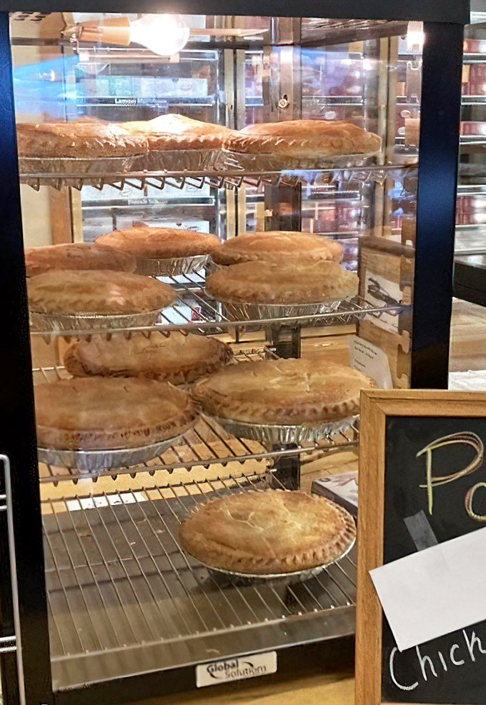 Behind glass, these golden-crusted pot pies stand at attention like delicious soldiers. Your dinner plans have just been commandeered.