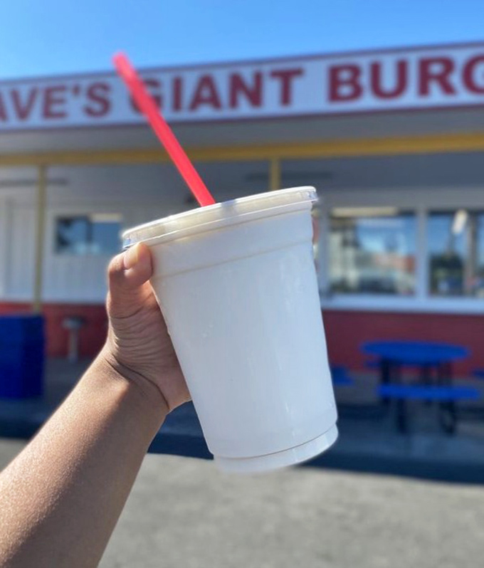 A shake with a view. Nothing complements Dave's iconic red and white exterior like a creamy milkshake held aloft in victory.
