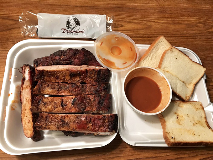 Ribs with the perfect smoke ring, served with white bread for sopping – nature's most perfect meal delivery system since hands.