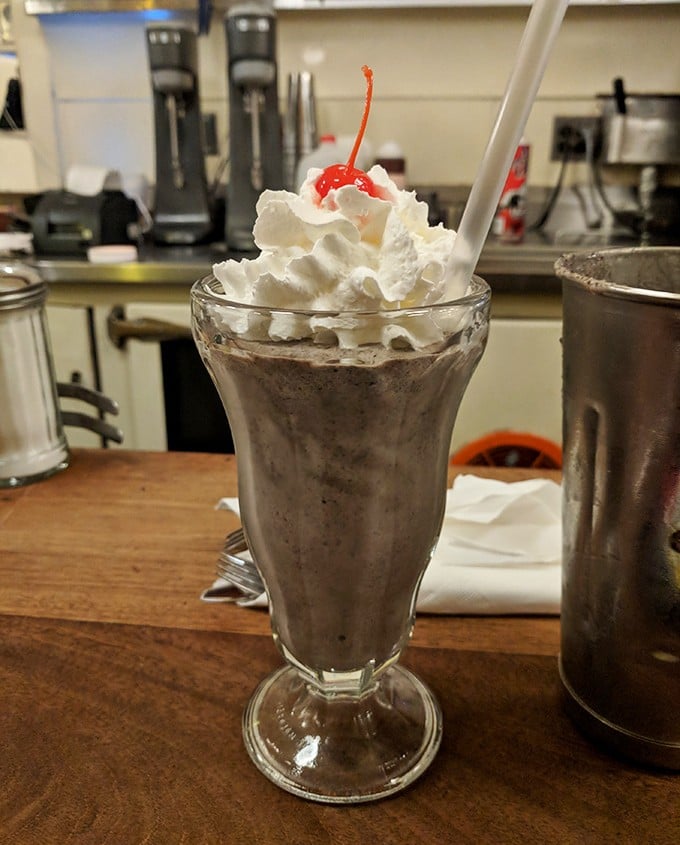 This isn't just a milkshake; it's a childhood memory in a glass, topped with a cloud of whipped cream and adult permission.