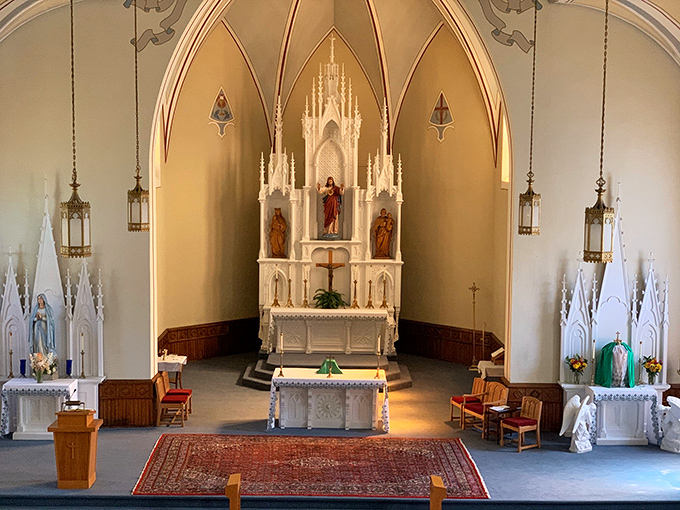Sacred Heart's stunning altar reaches heavenward with Gothic splendor, a surprisingly ornate spiritual sanctuary in this humble river town.