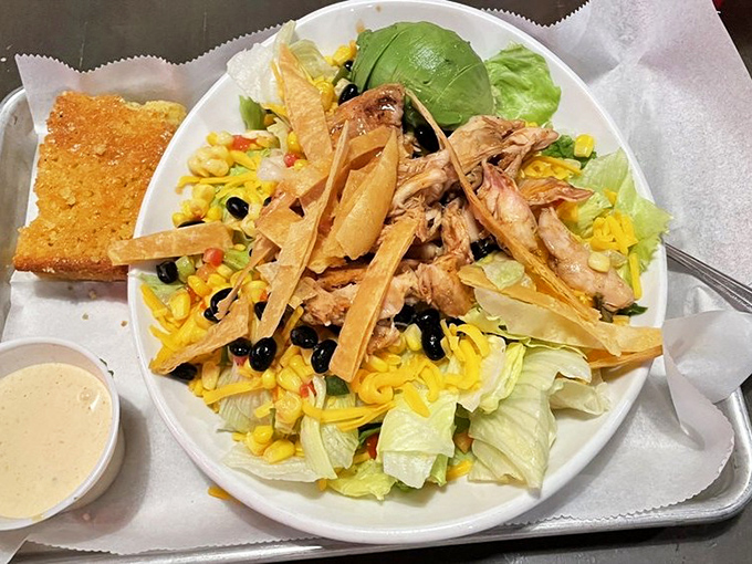 A salad that doesn't feel like punishment. Fresh greens, corn, black beans, and pulled chicken create the rare salad that barbecue enthusiasts actually want to order.