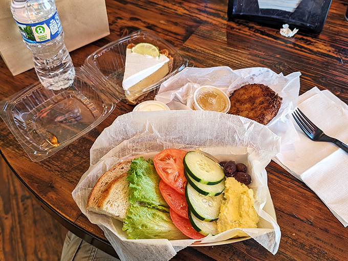 A fresh salad that doesn't apologize for being healthy—crisp vegetables and creamy hummus proving that not everything at a deli needs to be between bread.