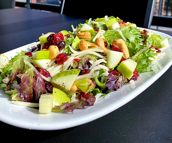 A vibrant harvest salad that proves eating your greens doesn't have to feel like punishment—those cranberries and apples are game-changers.