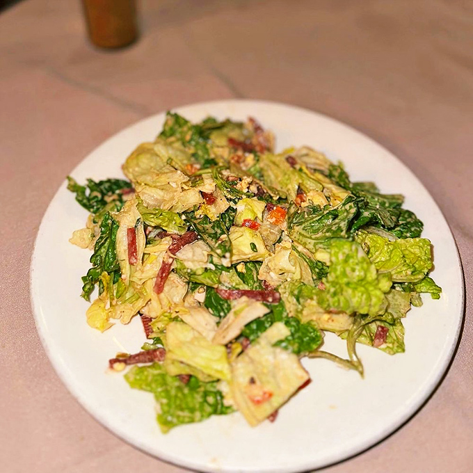 Even the salad gets the royal treatment here, tossed tableside with theatrical flair and house-made dressing.
