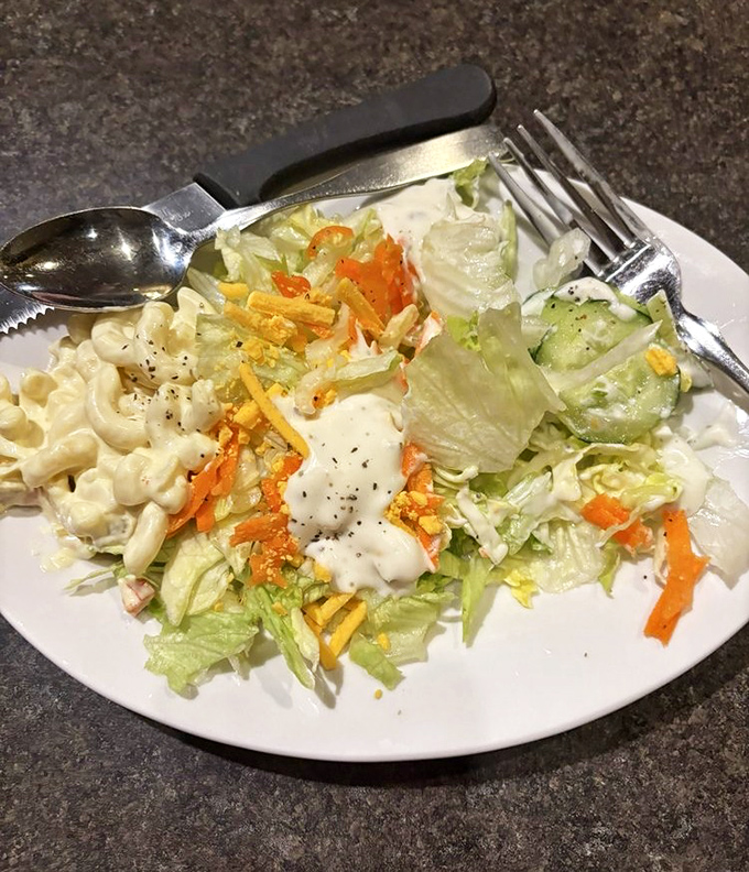 The salad plate offers a crisp counterpoint to all that hearty protein&mdash;fresh lettuce, shredded carrots, and creamy dressing create the perfect opening act for the main event.