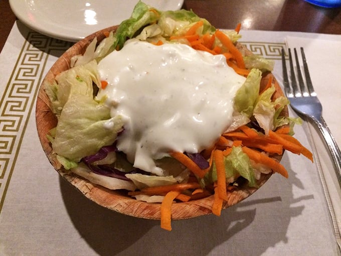 A salad served in a wooden bowl that somehow makes vegetables more appealing. It's not avoiding barbecue&mdash;it's supporting the main event. 
