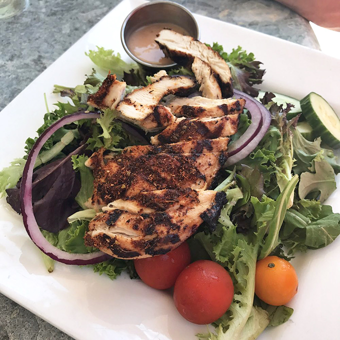 A salad that doesn't feel like punishment. Grilled chicken with the perfect char, garden-fresh veggies, and a dressing worth bottling and taking home.