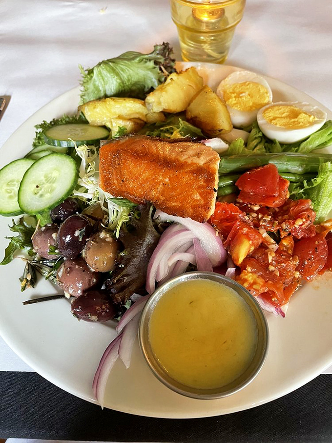 A Nicoise salad arranged with the precision of a small art installation. Every ingredient gets its moment in the spotlight while maintaining perfect harmony.