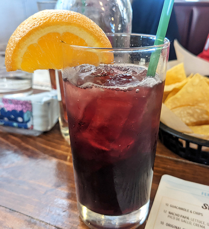 A sangria so photogenic it belongs on a magazine cover, garnished with orange and served alongside chips that won't last five minutes.
