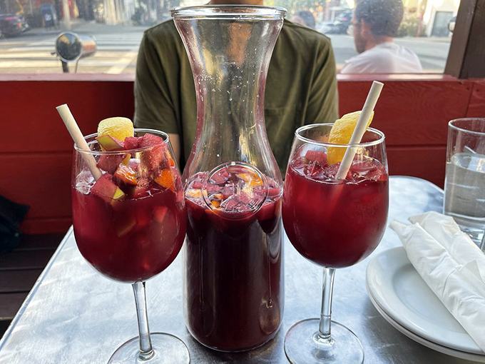 Sangria so vibrant it could double as jewelry. The fruit isn't just for show—it's been soaking up wine goodness like tiny boozy sponges.